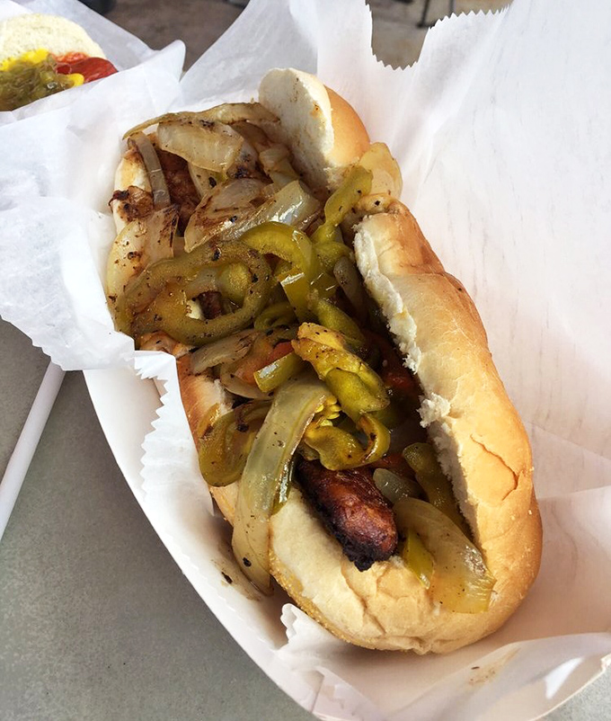 Grilled peppers and onions cascade over this Italian sausage like confetti at a flavor parade. Simple ingredients transformed by perfect execution.