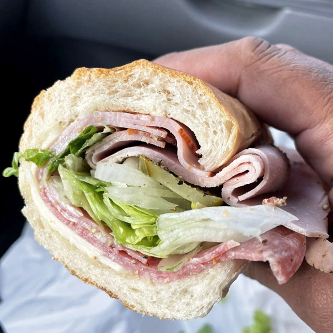 Layer upon glorious layer of Italian meats, cheese, and crisp lettuce. A sandwich architecture that would make Frank Lloyd Wright proud.
