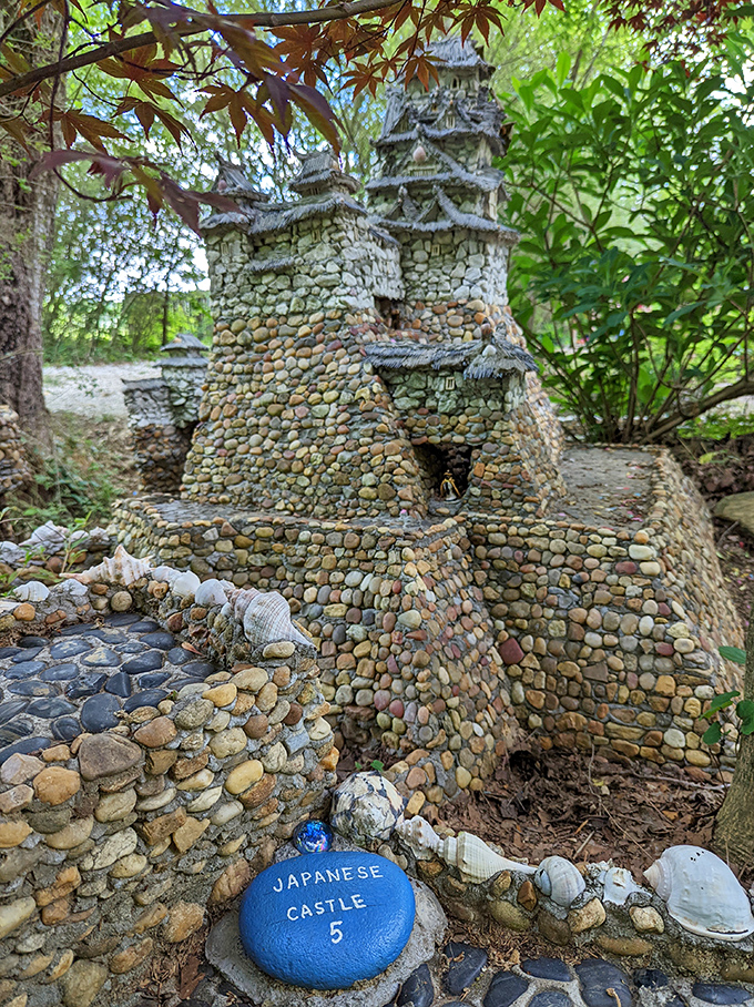 The Japanese Castle stands proudly among the greenery, its blue marker a helpful reminder for those of us who flunked Geography