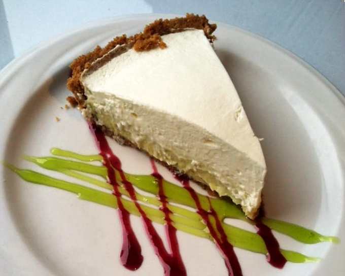 Key lime pie with artistic flair&mdash;that vibrant green and ruby drizzle isn't just Instagram bait; it's a flavor explosion waiting to happen.