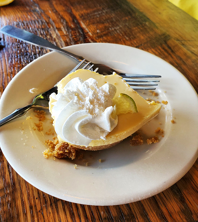 Key lime pie that strikes that perfect balance between tart and sweet, topped with a cloud of whipped cream that's begging for a fork dive.