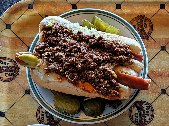 When a hot dog gets the royal treatment: meat sauce blanketing the sausage like a savory duvet, with pickles standing guard against mundane meals.