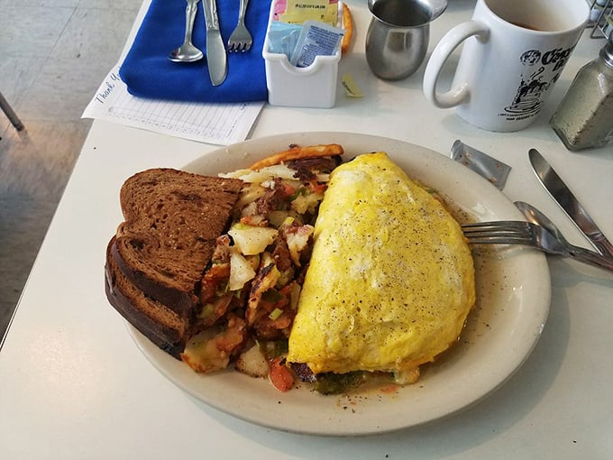 This omelet doesn't just come with hash browns&mdash;it's a complete breakfast ecosystem with perfectly toasted bread standing guard.