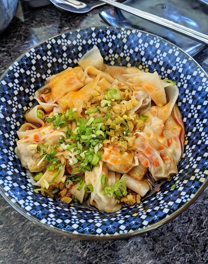 These delicate wontons swim in a sea of flavor, topped with vibrant herbs and scallions&mdash;proof that good things come in small packages.