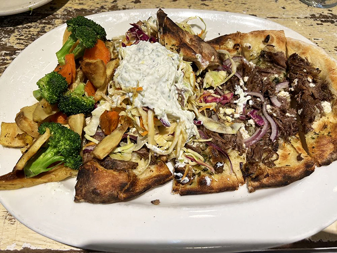 Flatbread that's anything but flat on flavor. The combination of tender lamb, fresh vegetables, and creamy sauce creates a pizza that would make an Italian grandmother nod in approval.