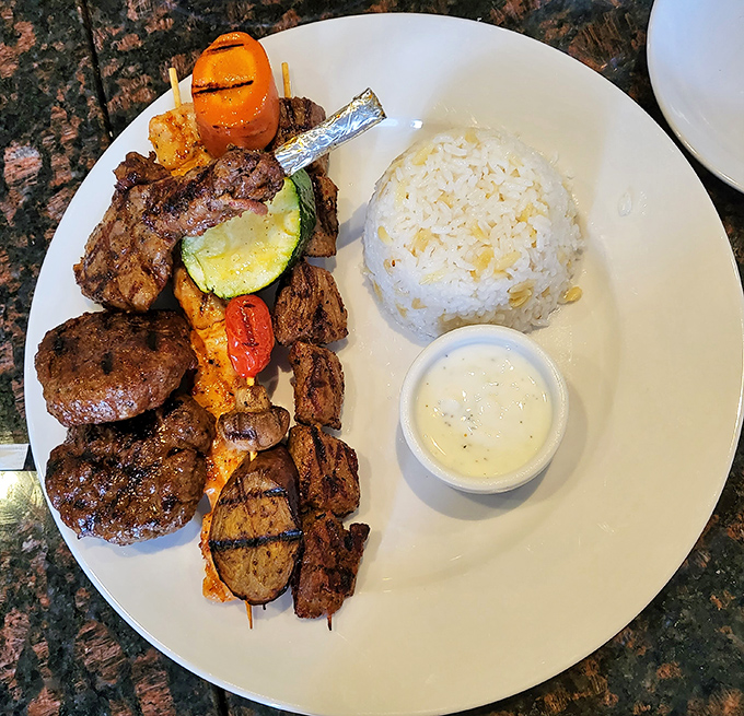 A carnivore's dream plate: perfectly grilled meats alongside colorful vegetables and fluffy rice. This isn't just dinner&mdash;it's a celebration on a plate.