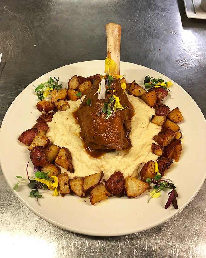 This lamb shank isn't just falling off the bone &ndash; it's practically jumping onto that cloud of mashed potatoes surrounded by roasted spuds.