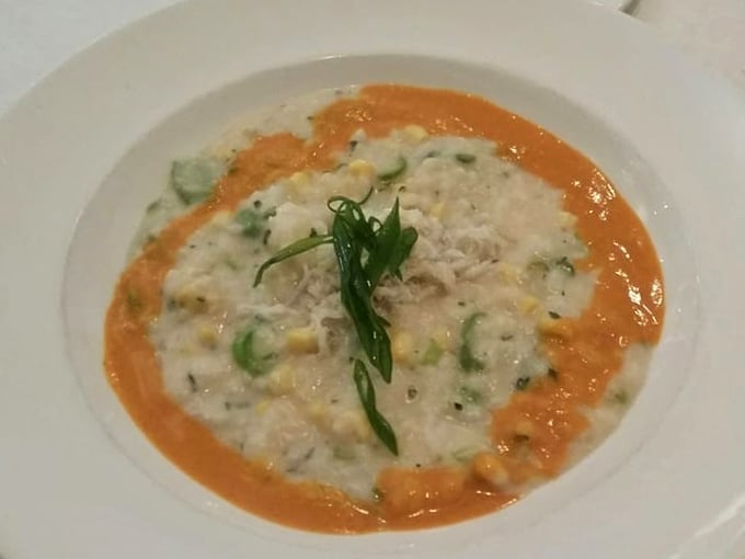 A bowl of comfort disguised as culinary art&mdash;creamy risotto cradles tender crab while the vibrant sauce creates a sunset on your plate.