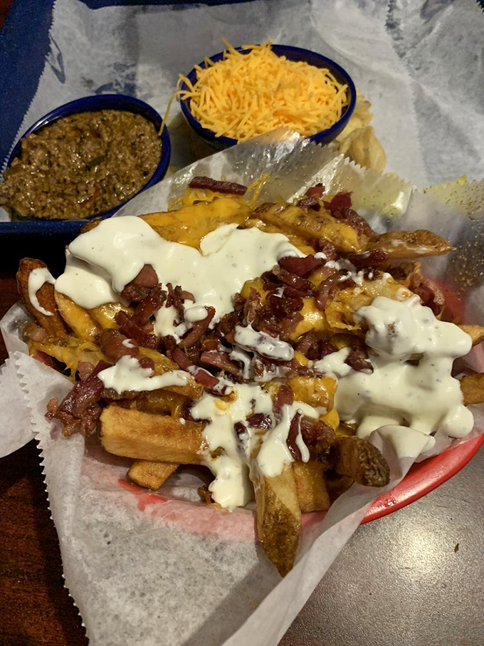Loaded fries that require a game plan &ndash; crispy potatoes buried under an avalanche of bacon, cheese, and ranch. Fork recommended, restraint optional.