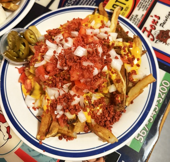 Loaded fries that don't mess around &ndash; topped with cheese, bacon bits, tomatoes and onions, they're a meal disguised as a side dish.
