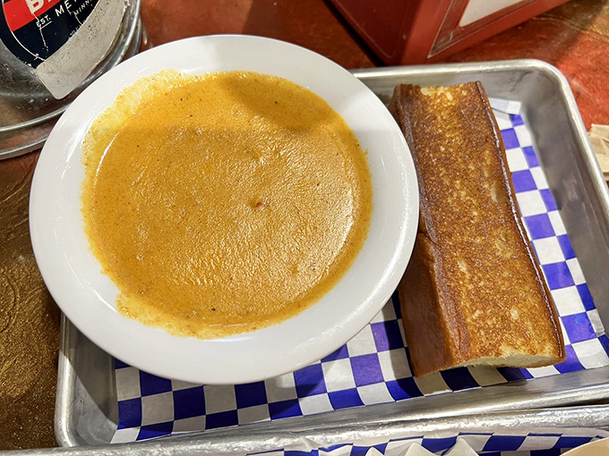 The lobster bisque glows with amber promise, a velvety ocean elixir that makes you wonder why soup spoons aren't bigger.