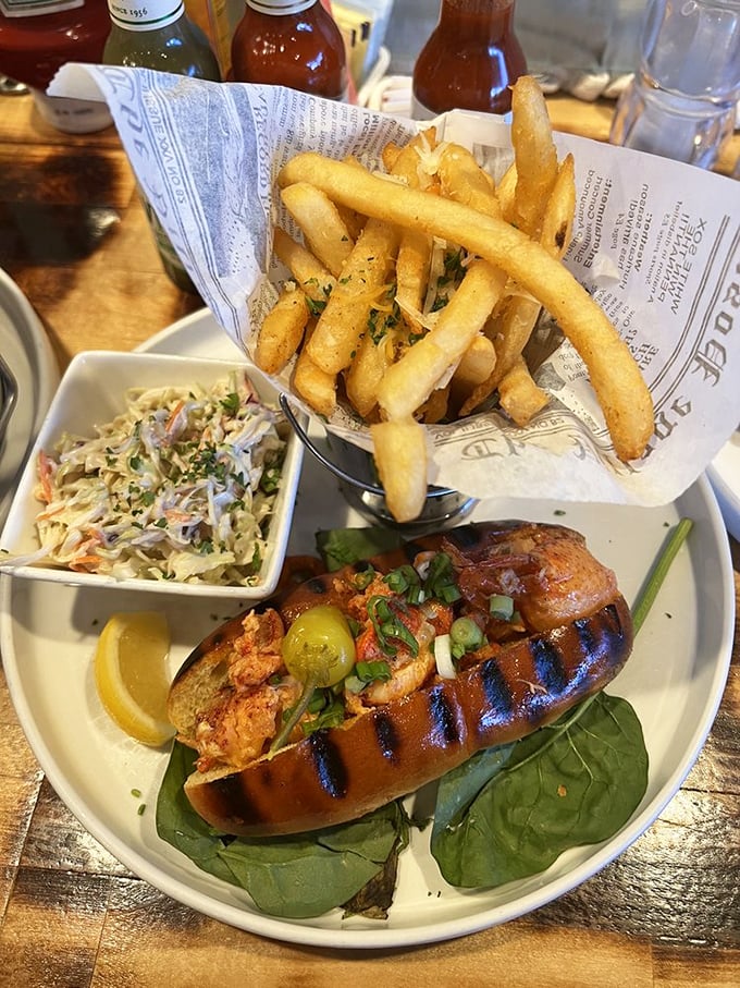 The lobster roll that launched a thousand return visits. Nestled in a perfectly toasted bun with just enough greenery to pretend it's healthy.