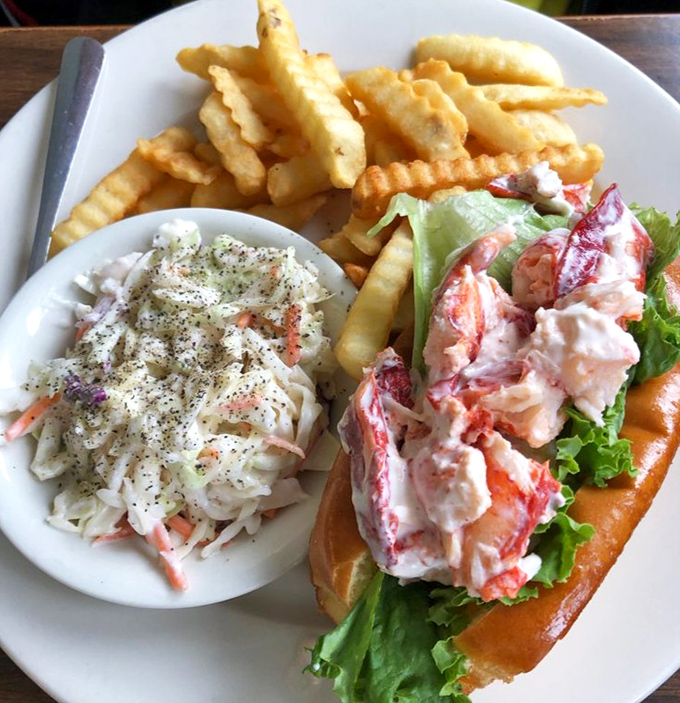 Maine's lobster roll philosophy: let the star of the show shine. Fresh lobster meat, minimal fuss, maximum flavor&mdash;coastal perfection on a toasted bun.