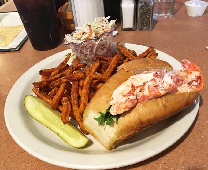 Maine's iconic lobster roll served unpretentiously&mdash;sweet meat, minimal dressing, proper bun. Those sweet potato fries are the supporting actor who steals the scene.