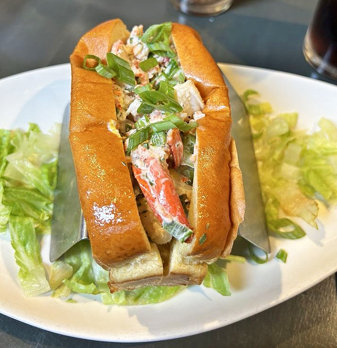 This lobster roll doesn't just speak of New England shores—it sings a full maritime opera with chunks of sweet meat cradled in buttery perfection.
