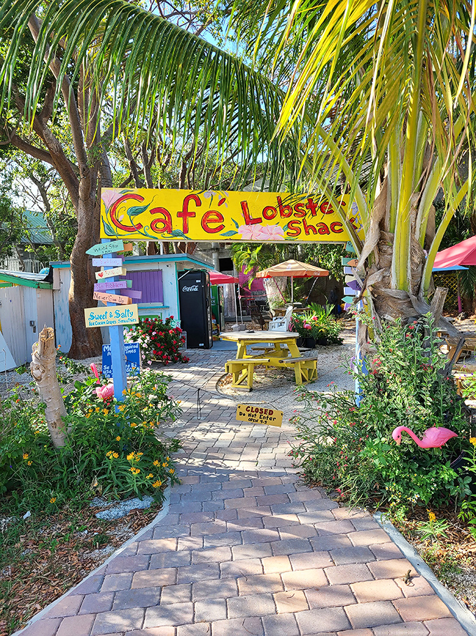 The Lobster Shack's vibrant sign and yellow picnic table promise the kind of casual Keys dining experience where flip-flops are the only dress code.