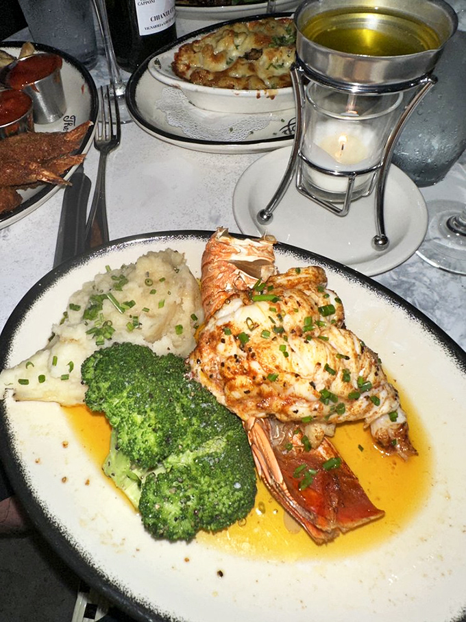 Lobster tail that's dressed for the occasion, bathed in butter and ready for its close-up. The broccoli is just there for moral support.