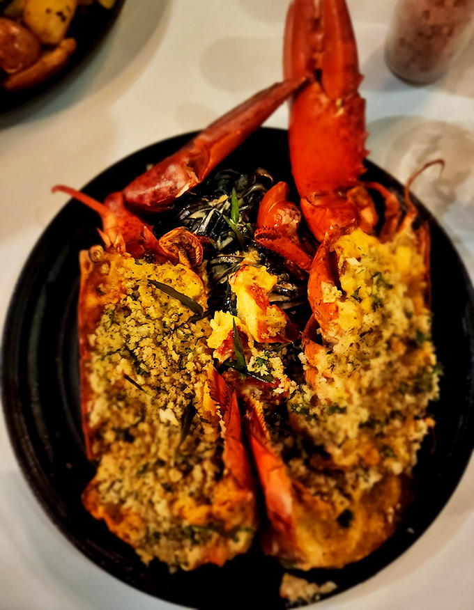 Lobster doesn't get more dressed up than this—split, stuffed, and ready for its close-up with a supporting cast of perfect sides.