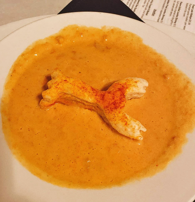 The lobster bisque arrives with its own pastry mascot &ndash; a buttery, flaky lobster-shaped companion swimming in velvety, rich soup that warms the soul.