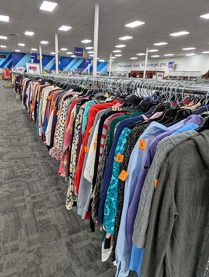 A rainbow of possibilities stretches to the horizon. Each hanger holds not just clothing, but potential identities waiting to be discovered.