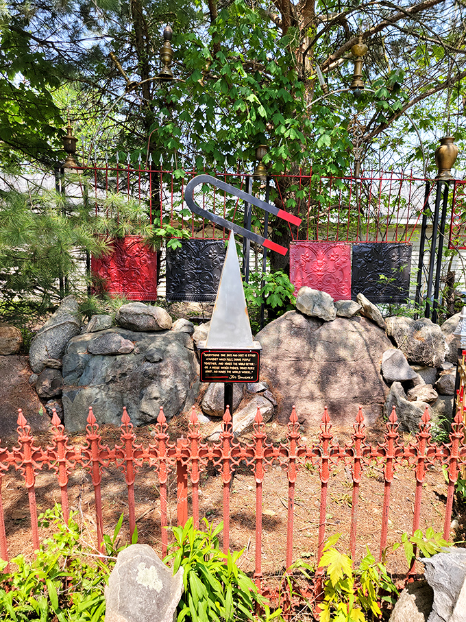 Red fencing and carefully placed stones create a striking visual contrast. Someone clearly understood that good art requires both boundaries and freedom.