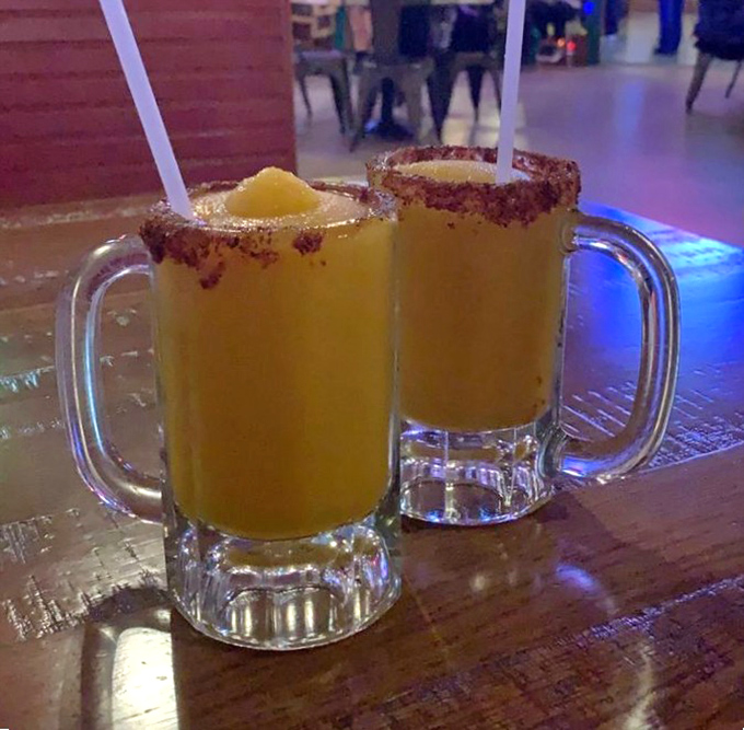 These mango margaritas aren't just drinks; they're vacation in a glass, with a rim that's dressed better than most people at the party.