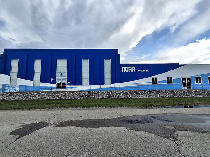 The NOAA Thunder Bay National Marine Sanctuary building stands bold in blue and white, housing treasures and tales from the depths of Lake Huron's shipwreck coast.