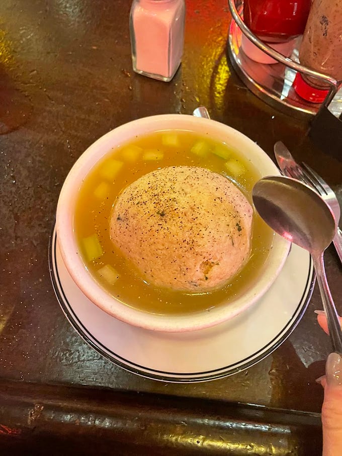 The matzo ball soup&mdash;golden broth cradling a perfect sphere of comfort. Penicillin might cure illness, but this cures the soul.