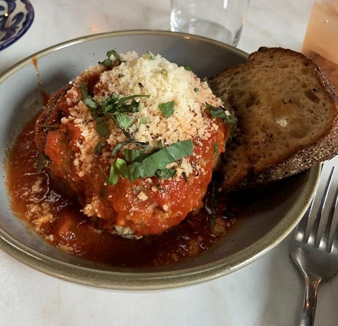 A meatball so perfect it deserves its own Renaissance painting. Swimming in tomato sauce with a shower of parmesan and fresh basil.