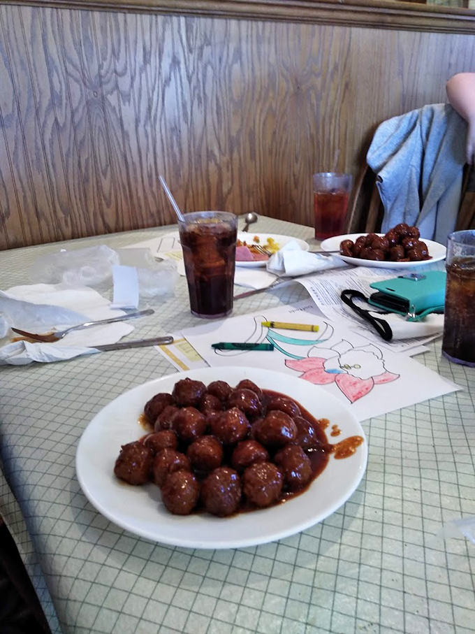 These saucy meatballs aren't just food—they're time machines to Sunday family dinners. The kids' coloring pages add that authentic "we feed families" touch.