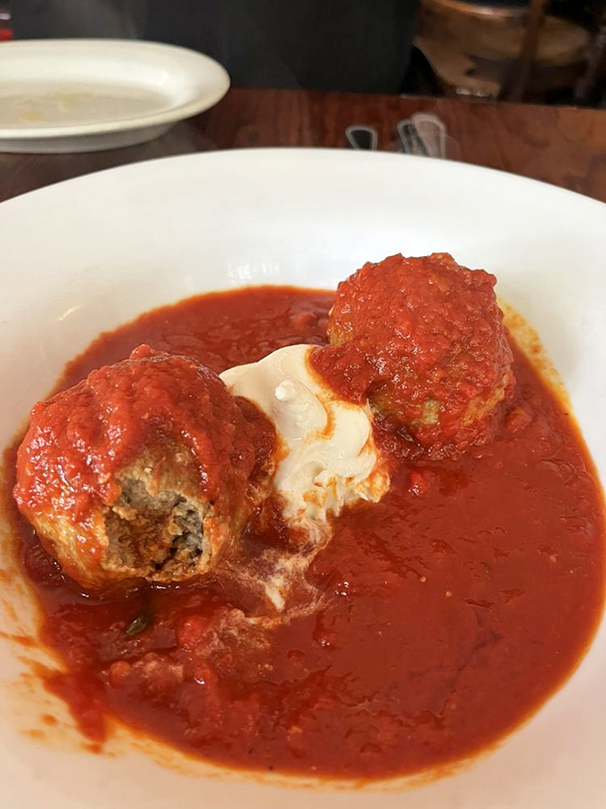 Those meatballs sitting in red sauce aren't just food, they're a masterclass in how to make meat sing opera.