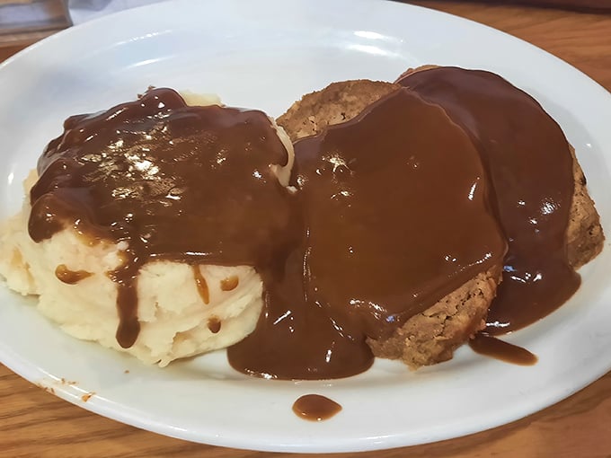 Meatloaf swimming in gravy &ndash; comfort food that hugs you from the inside. This plate makes Monday feel like a warm Saturday afternoon.