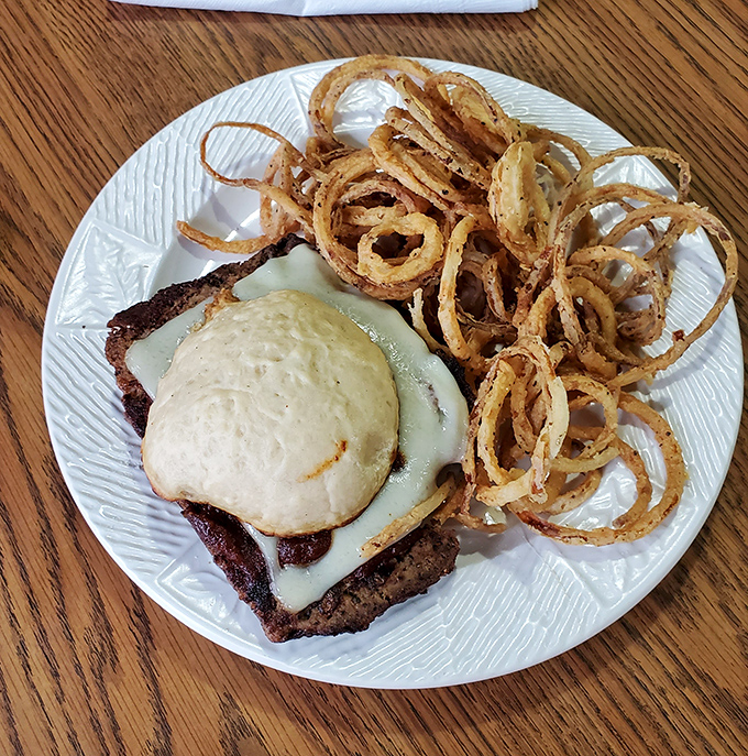The burger that launched a thousand napkins &ndash; those crispy onion rings aren't just garnish, they're the crown jewels of this royal feast.