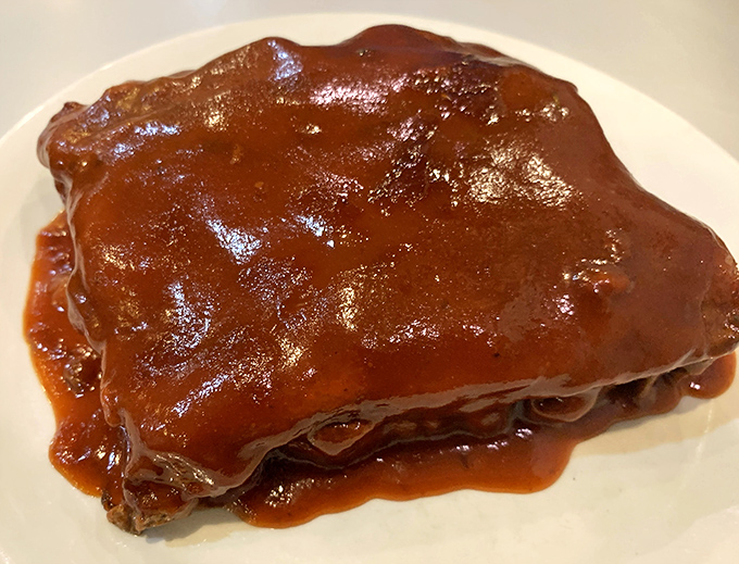 BBQ ribs glazed to perfection, the kind that make you forget napkins were ever invented.
