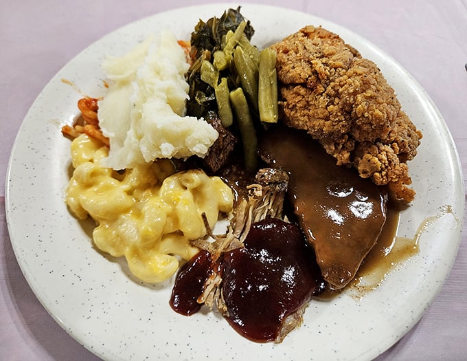 Southern harmony on a plate &ndash; creamy mac and cheese, tender greens, and country-fried perfection with gravy.