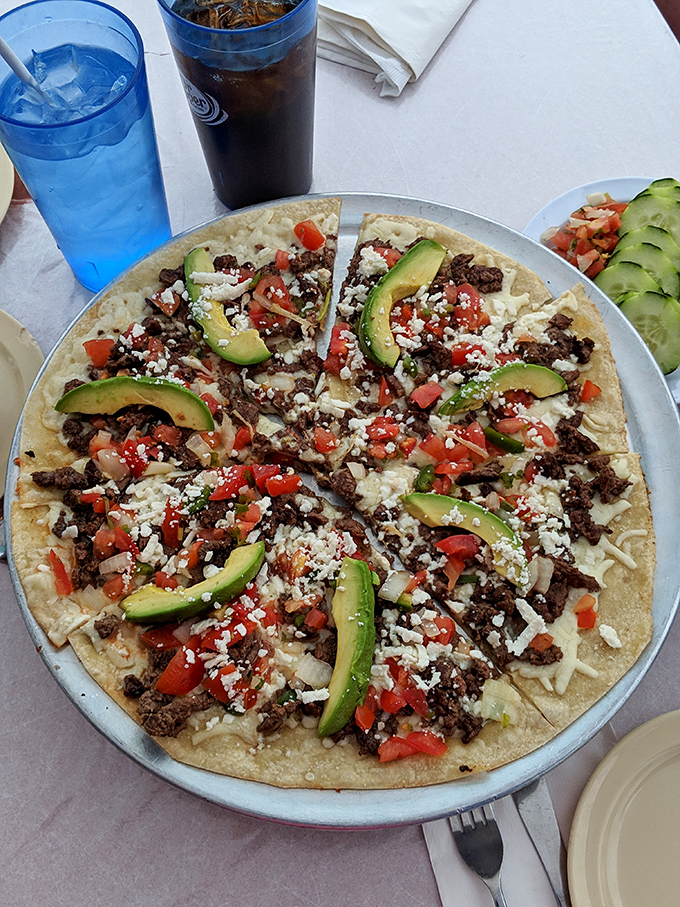 This Mexican pizza isn't just food&mdash;it's edible architecture, layered with avocado, cheese, and enough flavor to wake up your taste buds.