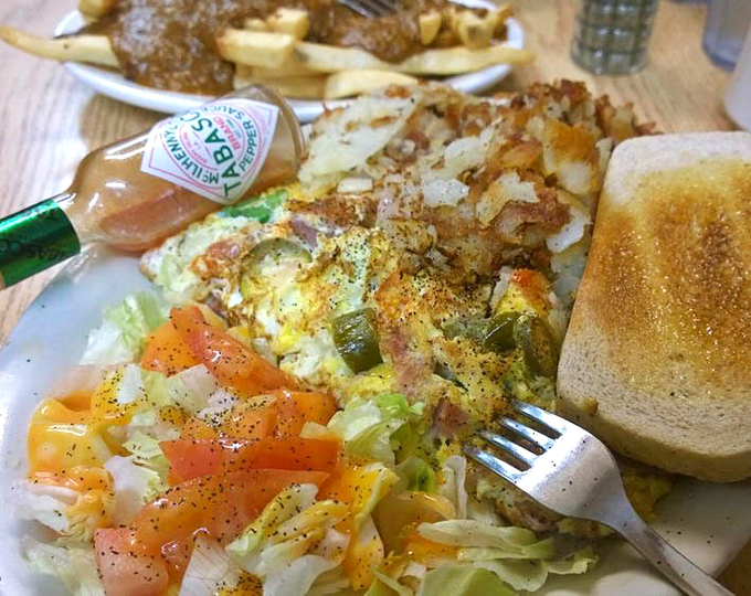 Breakfast artistry on full display. This veggie-packed omelet proves that sometimes the most colorful food is found in the most unassuming places.