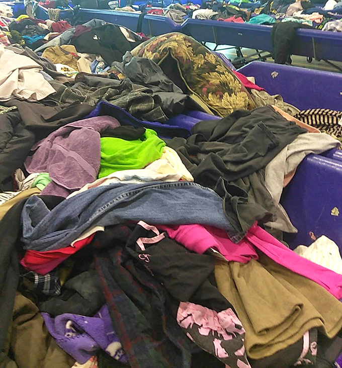 A textile mountain range where that perfect vintage jacket might be hiding under someone's discarded holiday sweater. The thrill is in the hunt!