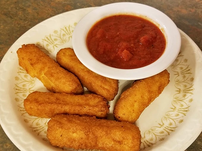 Golden-fried mozzarella sticks with marinara&mdash;proof that simple pleasures are often the most satisfying. Crispy outside, molten inside, perfect always.