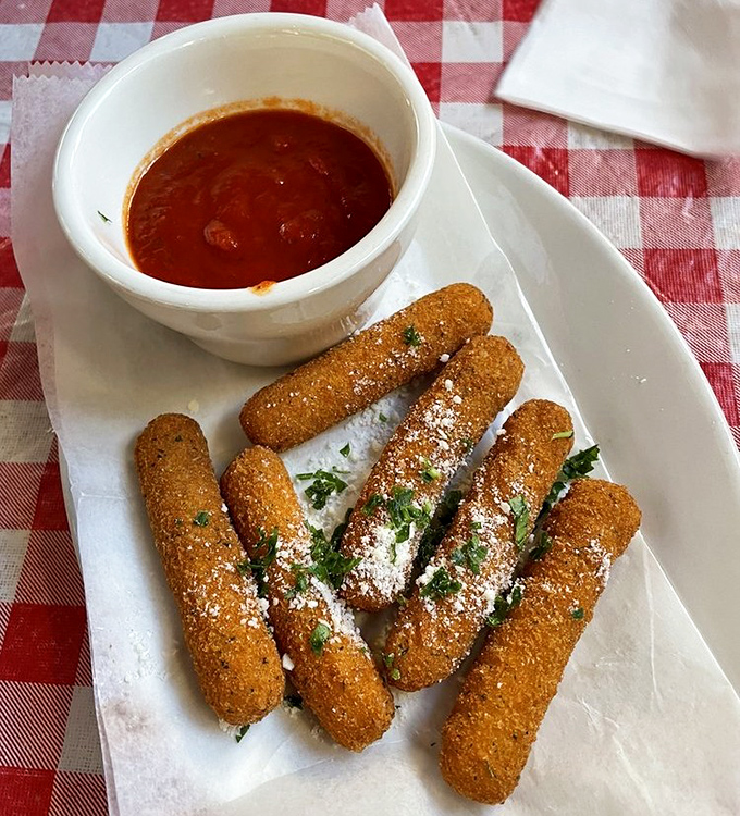 Golden-brown mozzarella sticks with that perfect pull-apart cheese stretch &ndash; the adult version of childhood joy, complete with marinara dipping sauce.