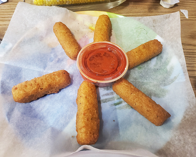 Mozzarella sticks arranged like a sunburst around marinara—proof that even the simplest appetizers get the royal treatment at Under the Pier.