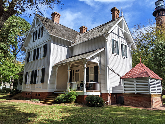 The keeper's house stands as a testament to coastal architecture, where function meets charm in a white-clapboard package of historical delight.