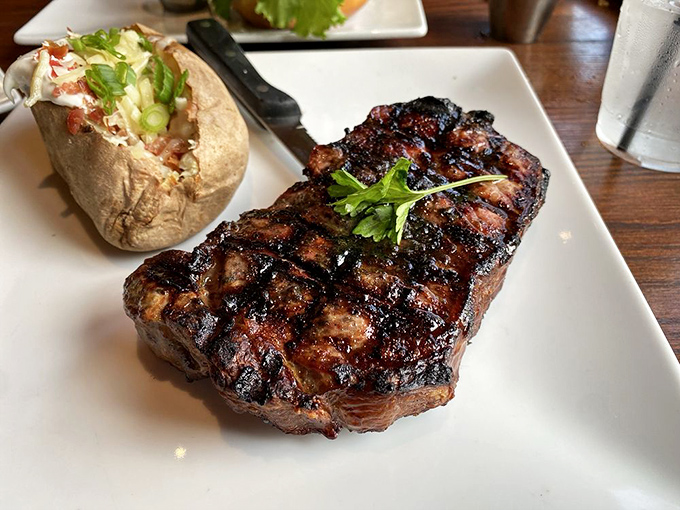 Land meets sea in perfect harmony &ndash; a perfectly grilled New York strip with a loaded baked potato standing by for backup.
