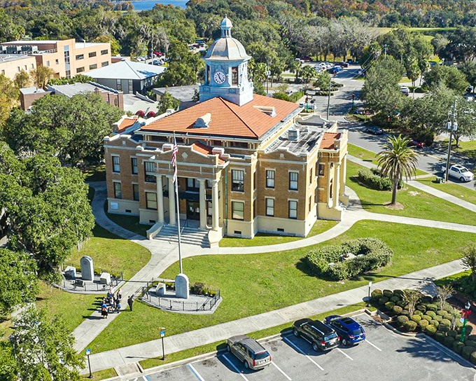 Another angle of the courthouse reveals its true grandeur, surrounded by palm trees that whisper "Florida living" without shouting "tourist trap prices."