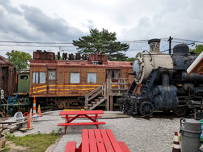 A rustic caboose and vintage locomotive create the perfect backdrop for picnic tables where train enthusiasts gather.