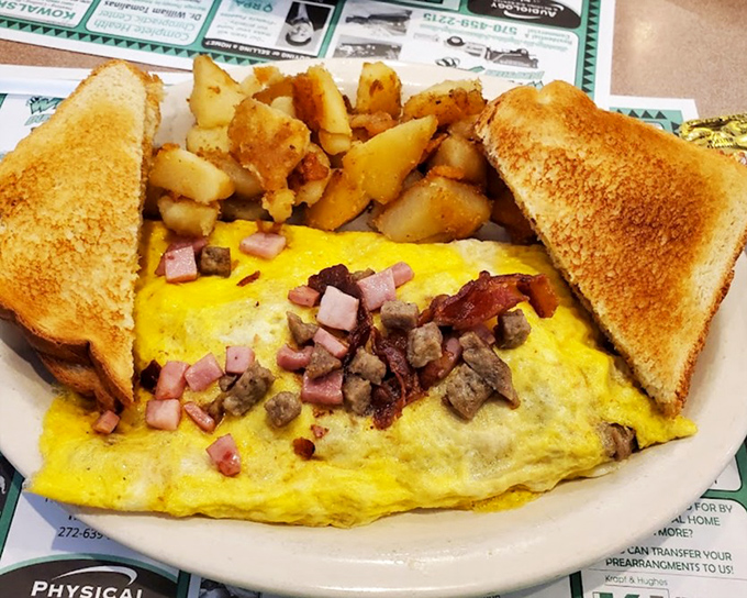 This omelet has more fillings than my last dental appointment, but infinitely more enjoyable&mdash;ham, cheese, and veggies nestled in fluffy eggs.
