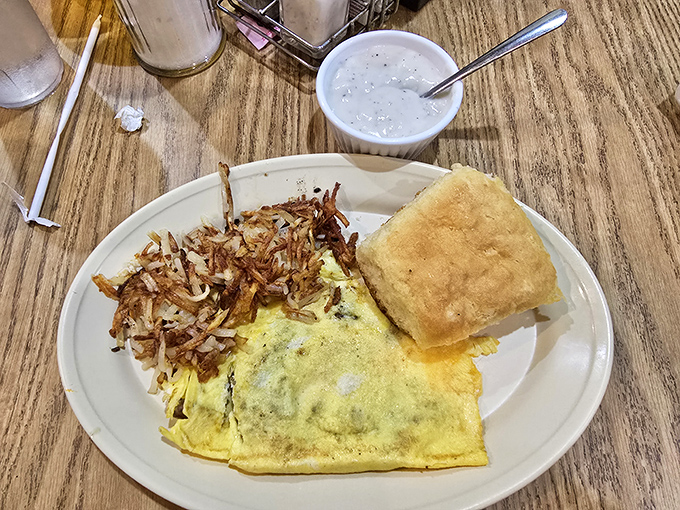 An omelet that knows its purpose in life: to deliver maximum flavor with crispy hash browns and a biscuit that could make your grandma jealous.