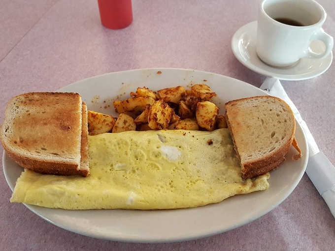 This omelet doesn't just sit on the plate—it lounges confidently, knowing it's about to make your morning significantly better.