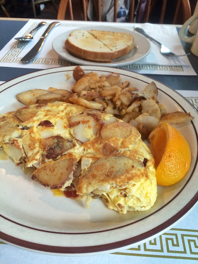 This isn't just an omelet—it's a masterclass in egg architecture. Notice how the potatoes mingle with the eggs like they've been friends forever.