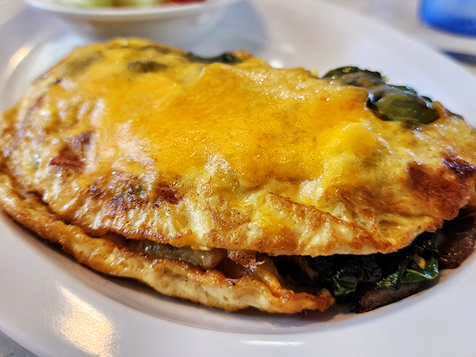 This isn't just an omelet&mdash;it's a golden envelope of happiness stuffed with enough fillings to make your cardiologist wince and your taste buds dance.